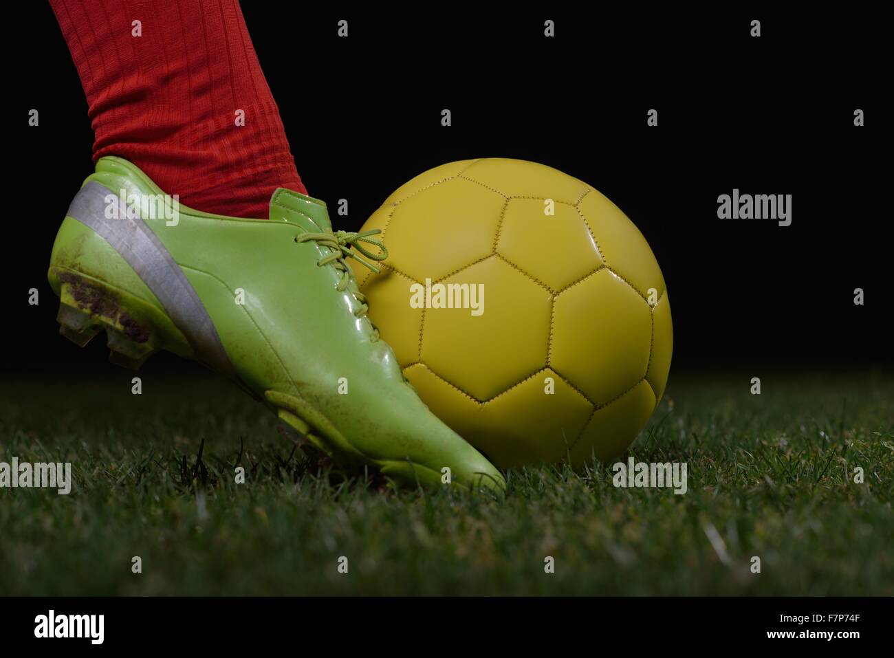 soccer player doing kick with ball on football stadium field isolated ...