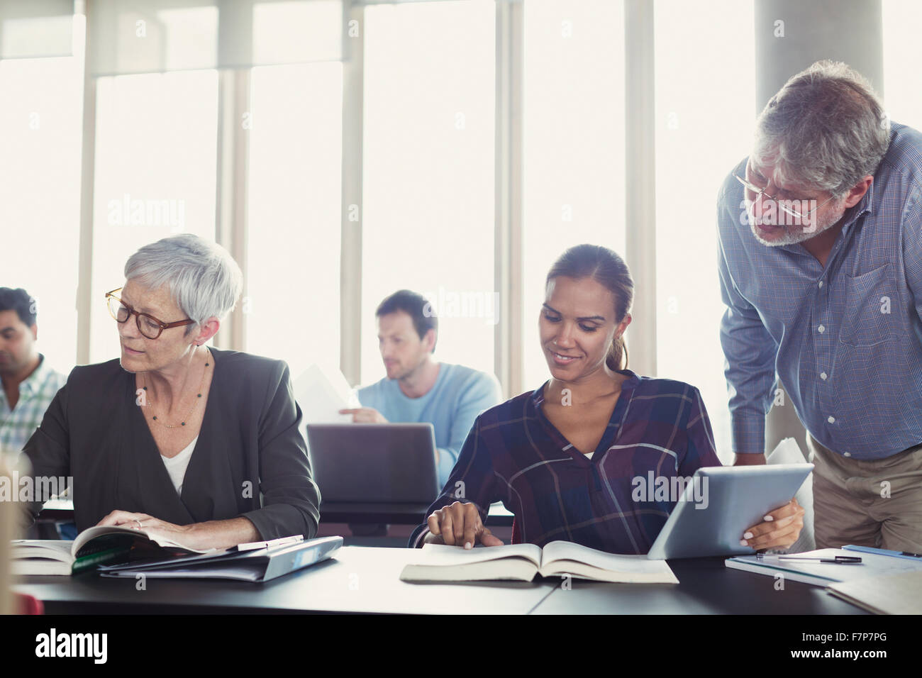 Students studying in adult education classroom Stock Photo - Alamy