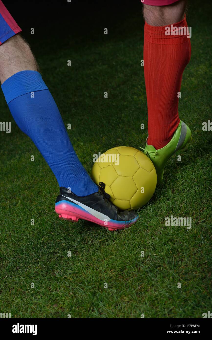 soccer player doing kick with ball on football stadium field isolated ...