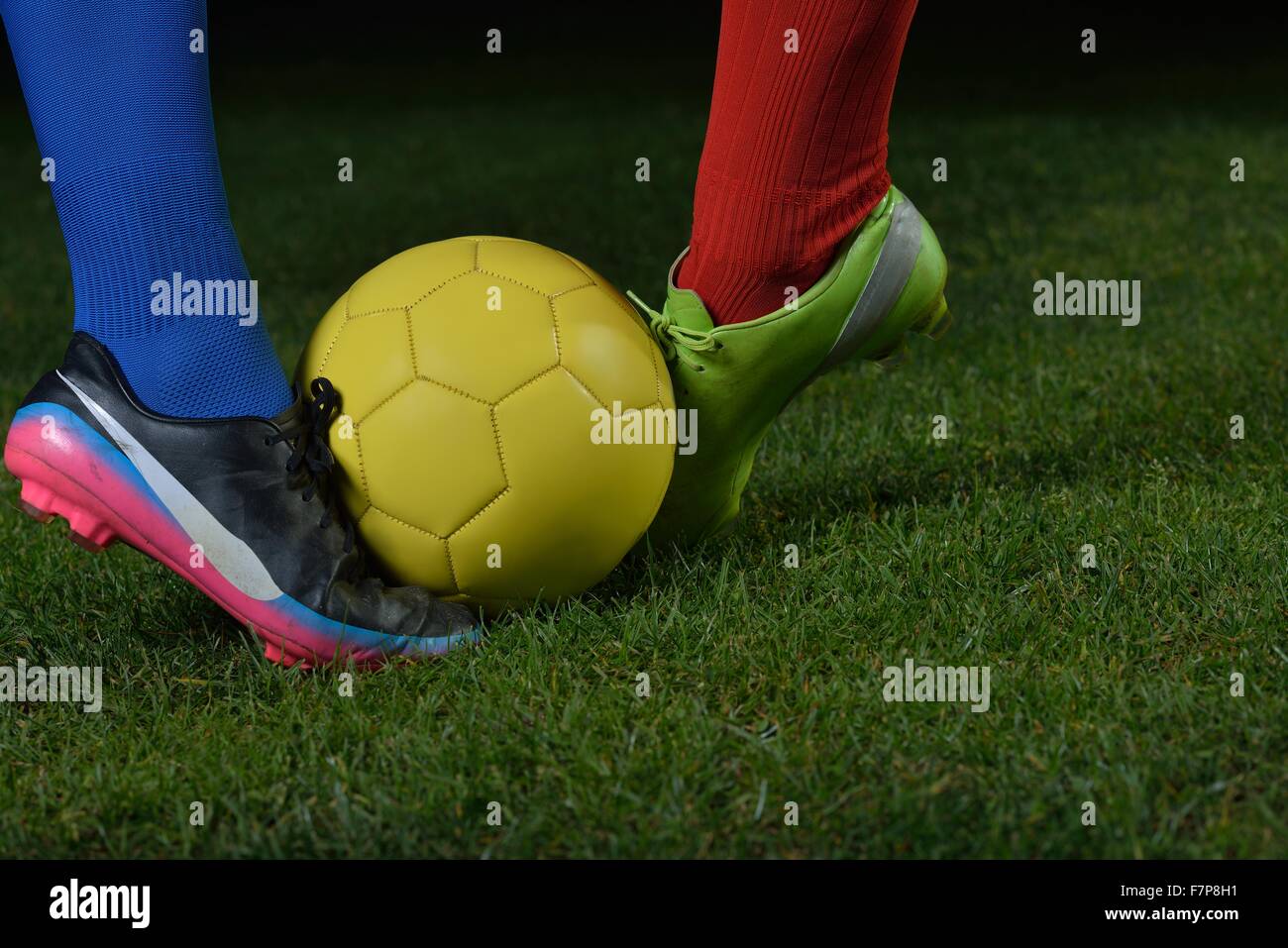 soccer player doing kick with ball on football stadium field isolated ...