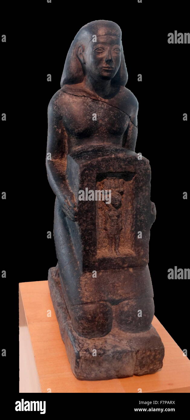 Ancient Egyptian statue of a man bearing a naos with the image of the ...