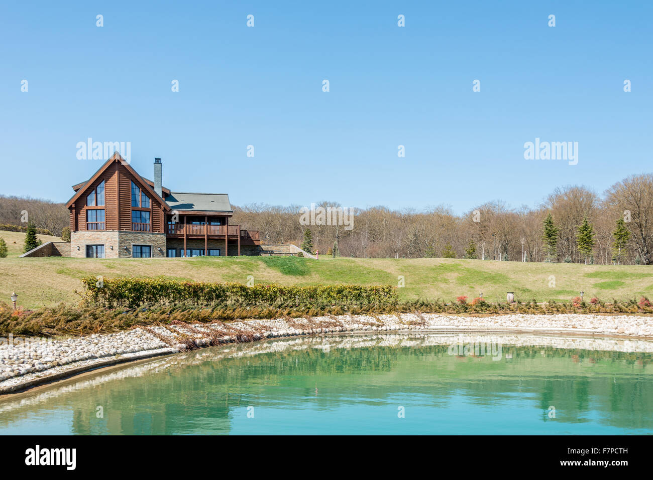 Modern house near water on bright day Stock Photo - Alamy