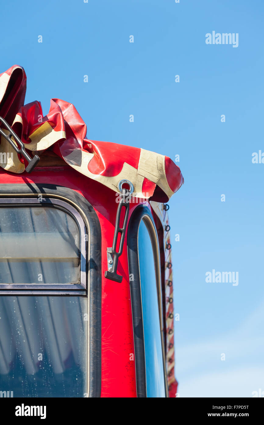 Open Air Bus / Detail of red bus windows with tarpaulin opened roof in ...