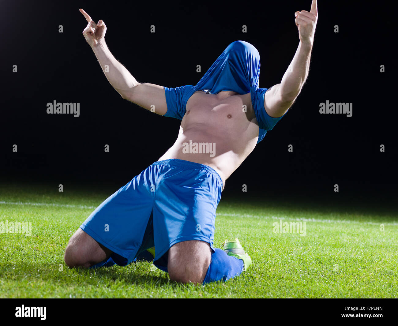 soccer player doing kick with ball on football stadium field isolated ...