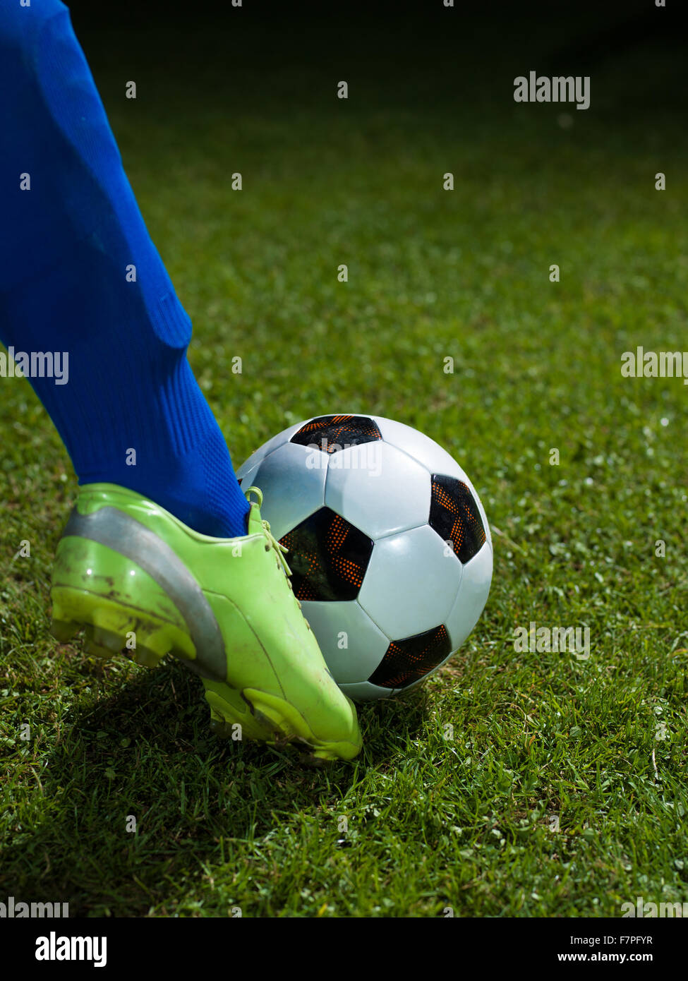 soccer player doing kick with ball on football stadium field isolated ...