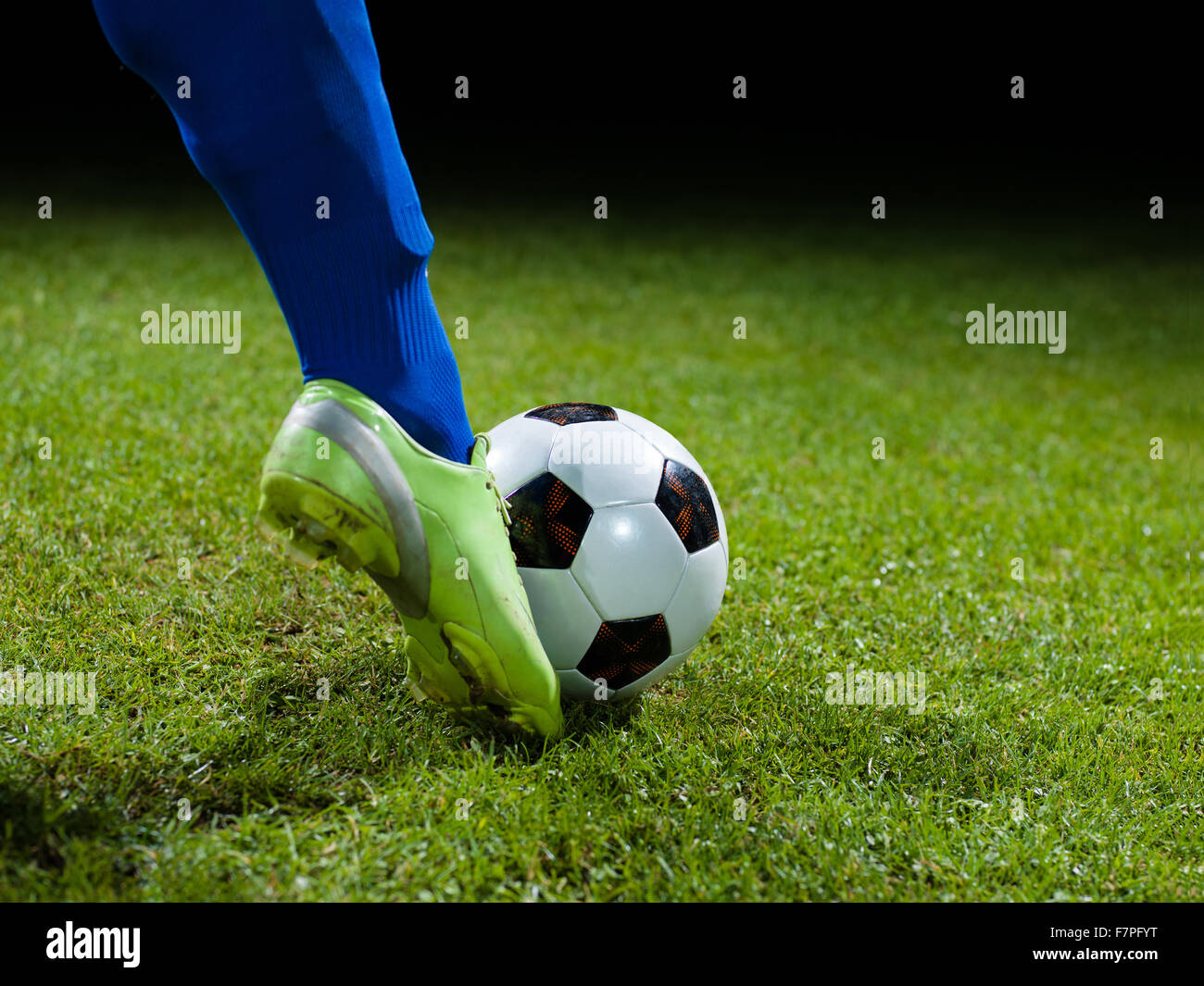 soccer player doing kick with ball on football stadium field isolated ...