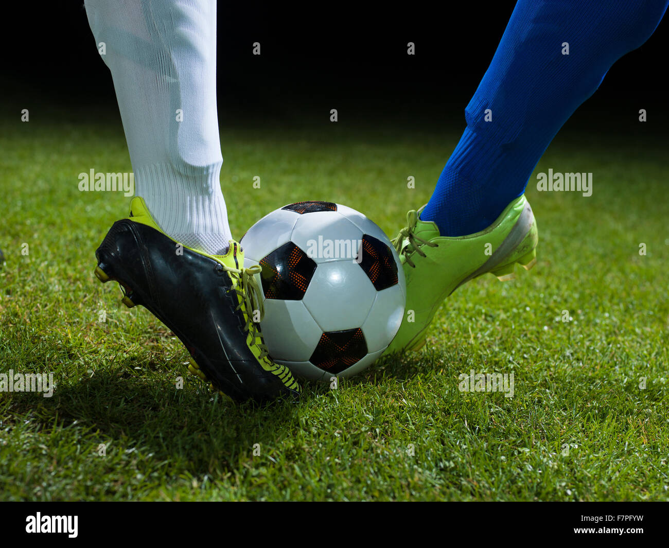 soccer player doing kick with ball on football stadium field isolated ...