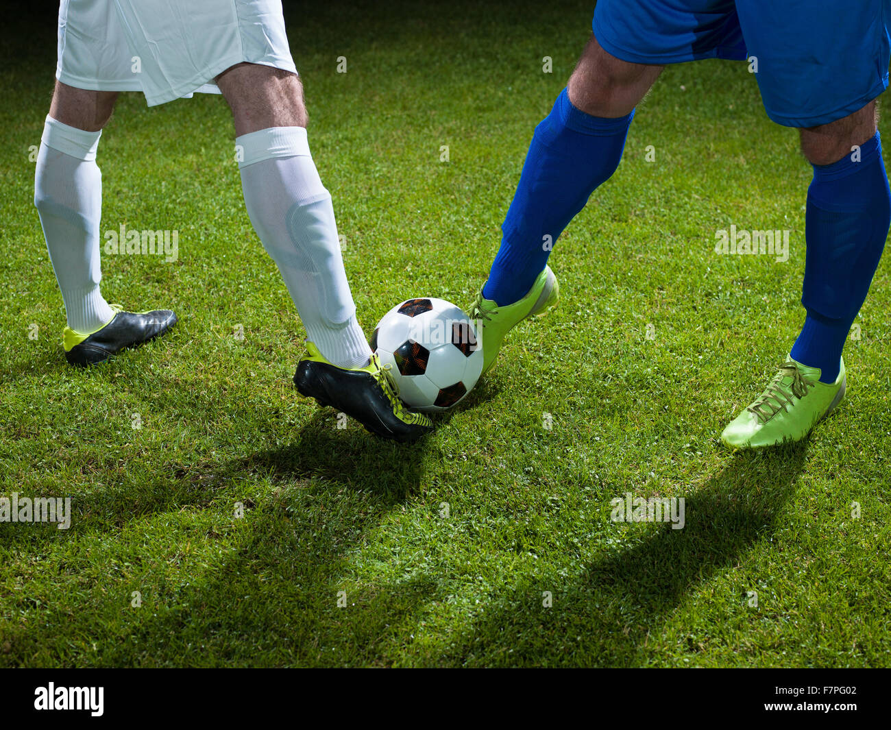 soccer player doing kick with ball on football stadium field isolated ...