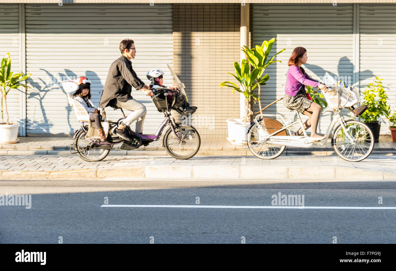 Japan Osaka local cyclists moving round town on cycle track away from ...
