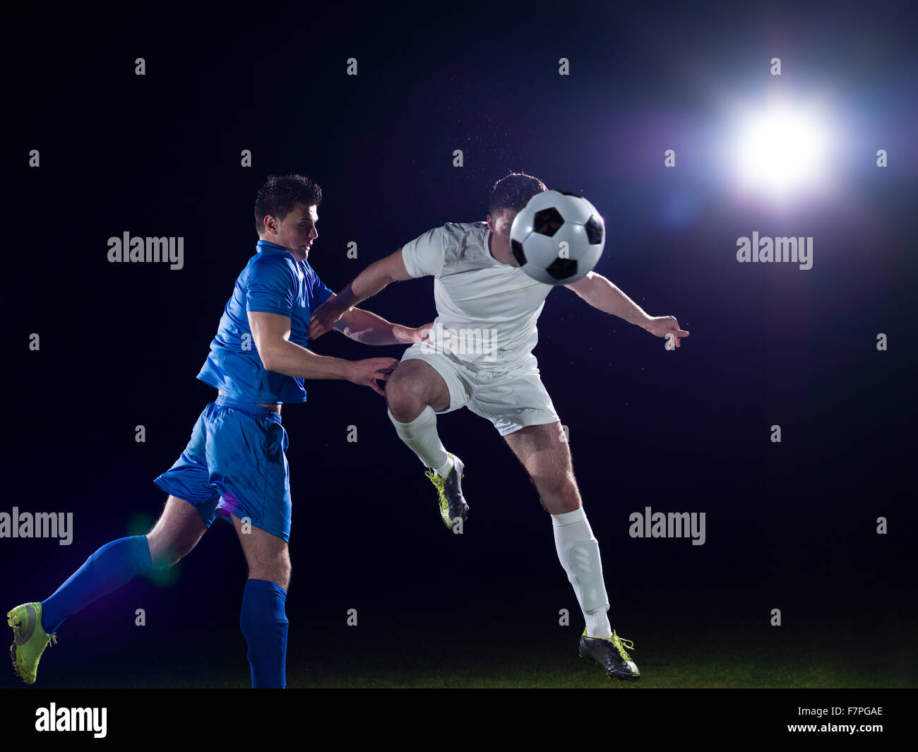 soccer player doing kick with ball on football stadium field isolated ...