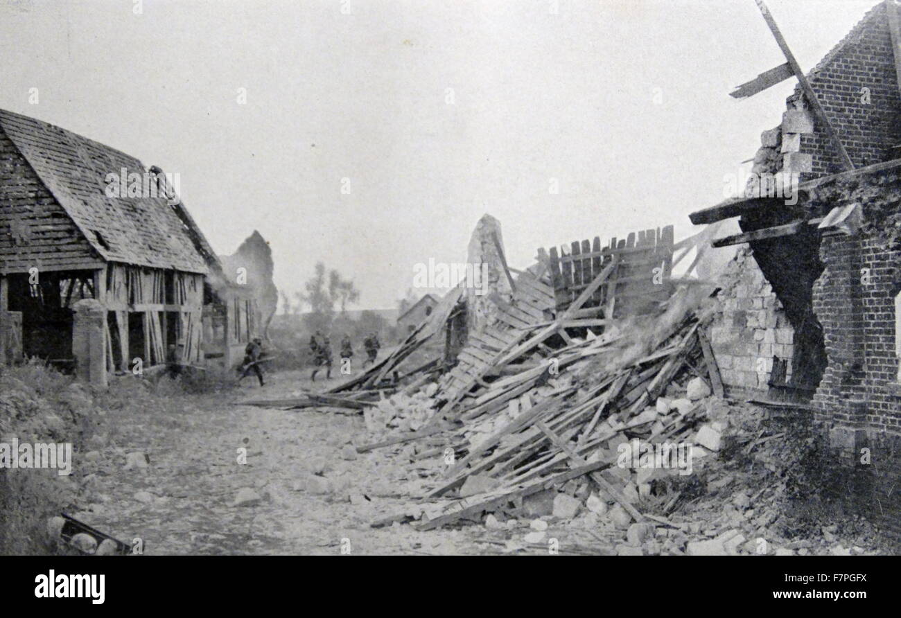 German soldiers advance across a ruined French village during World war ...