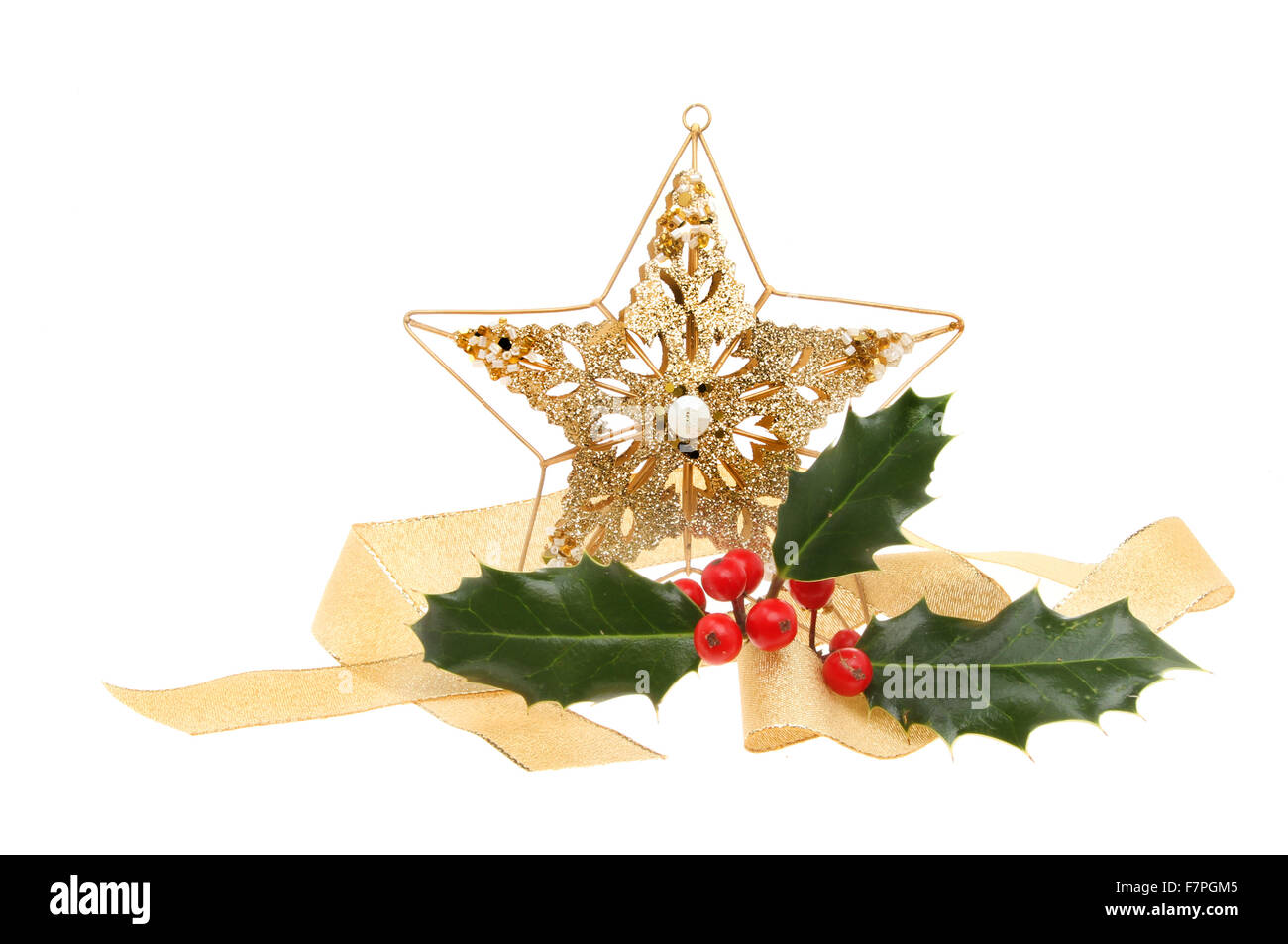 Christmas decoration, gold glitter star with gold ribbon and Holly ...