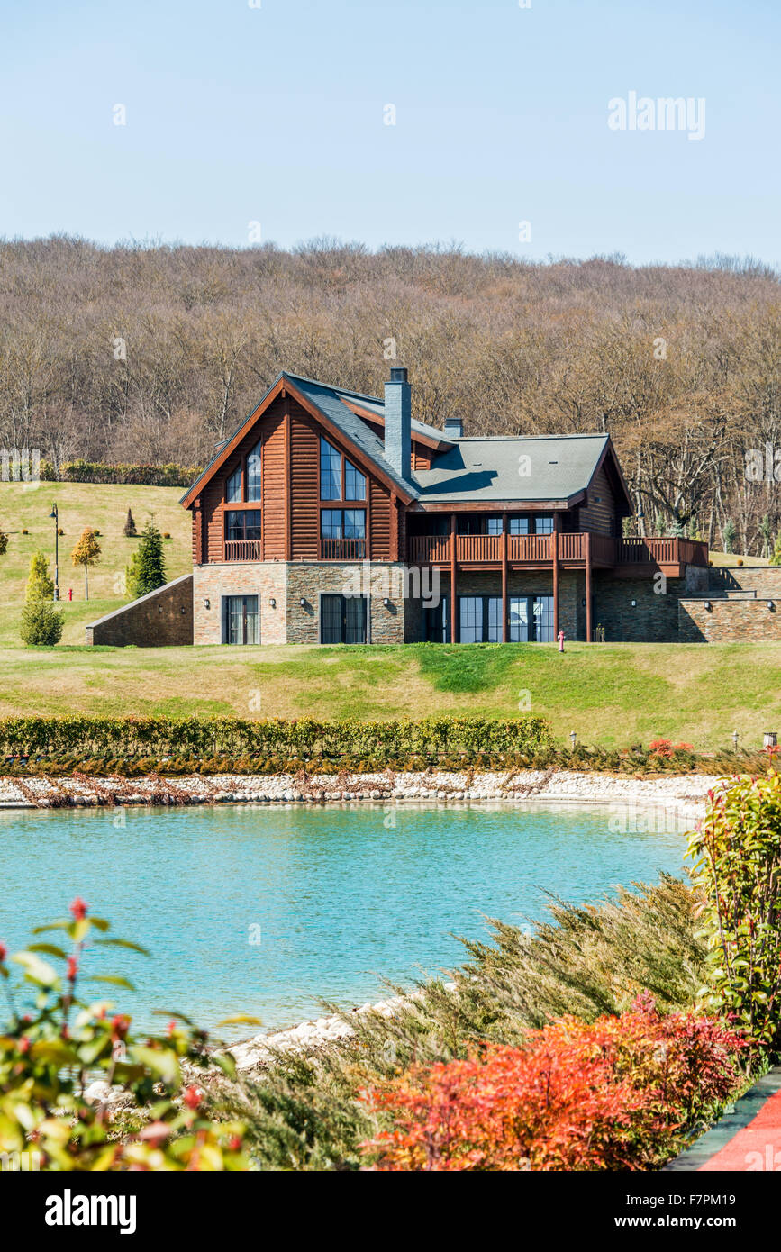 Modern house near water on bright day Stock Photo - Alamy