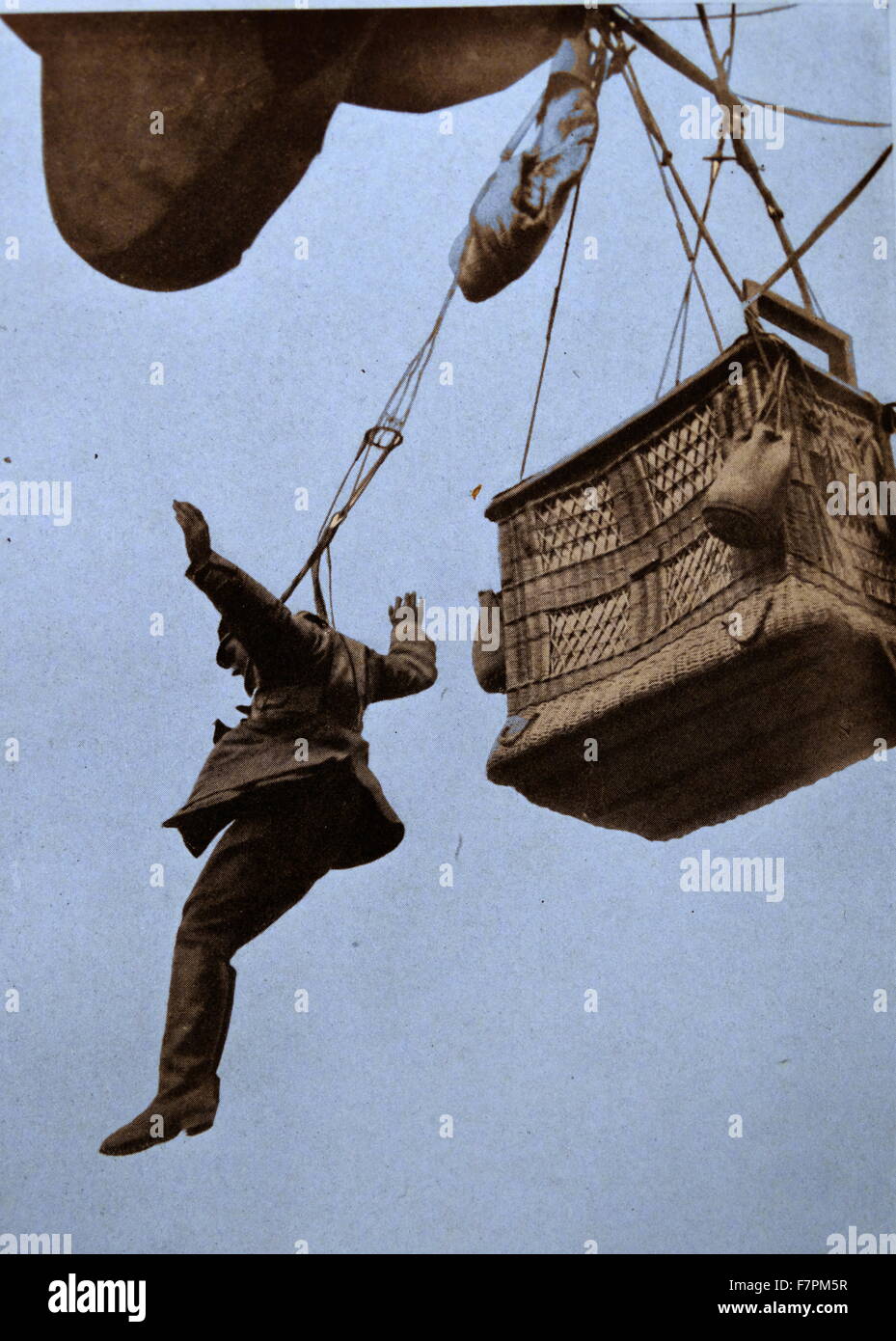 German aviator jumps using a parachute, from his airship after it is ...