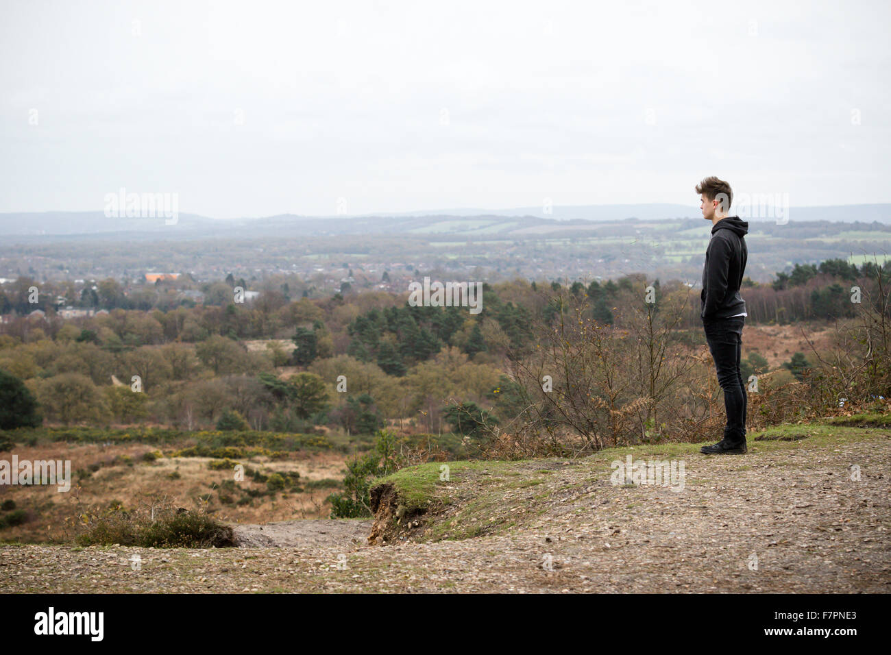 Teenage boy looking over a landscape Stock Photo - Alamy