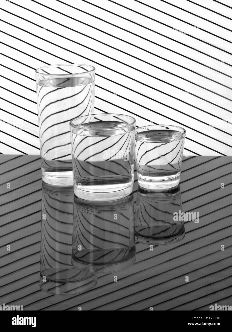 Glasses of water on striped cloth - refraction and reflection Stock ...