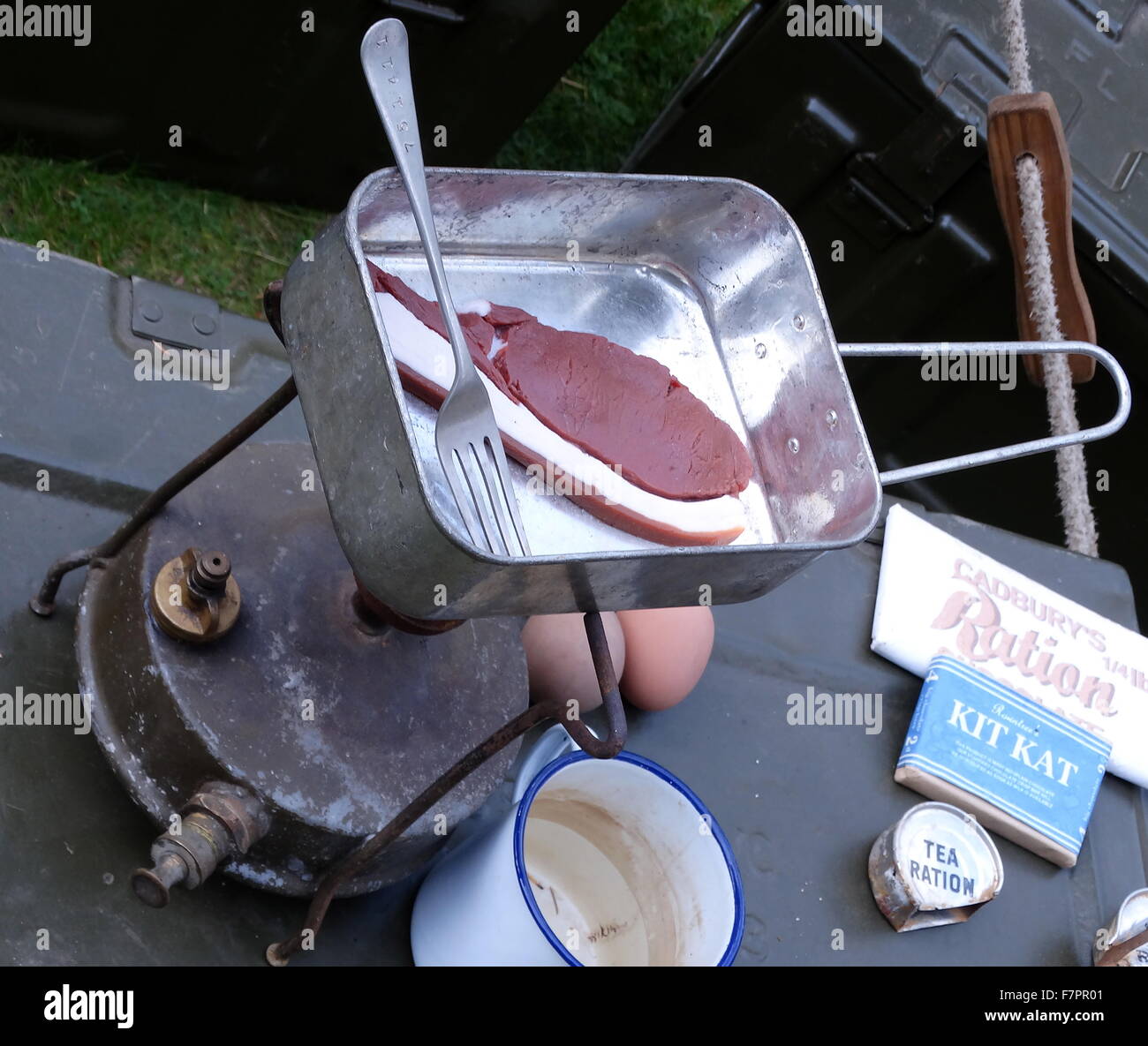 bacon cooking on a World war two army stove with chocolate bars nearby ...