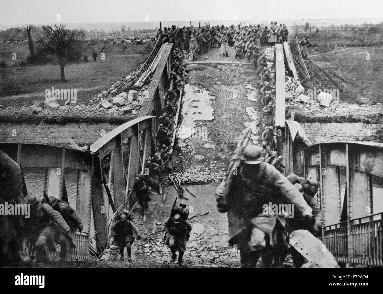 World war One: French troops climb across a ruined bridge 1915 Stock ...