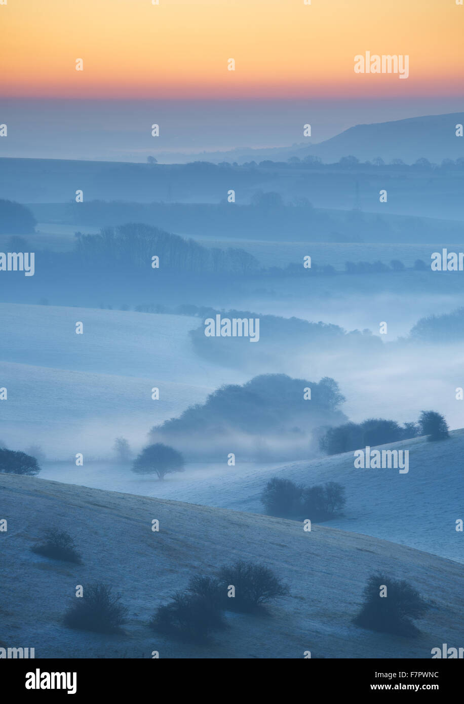 A misty view across the Sussex Downs at dawn, from Ditchling Beacon ...