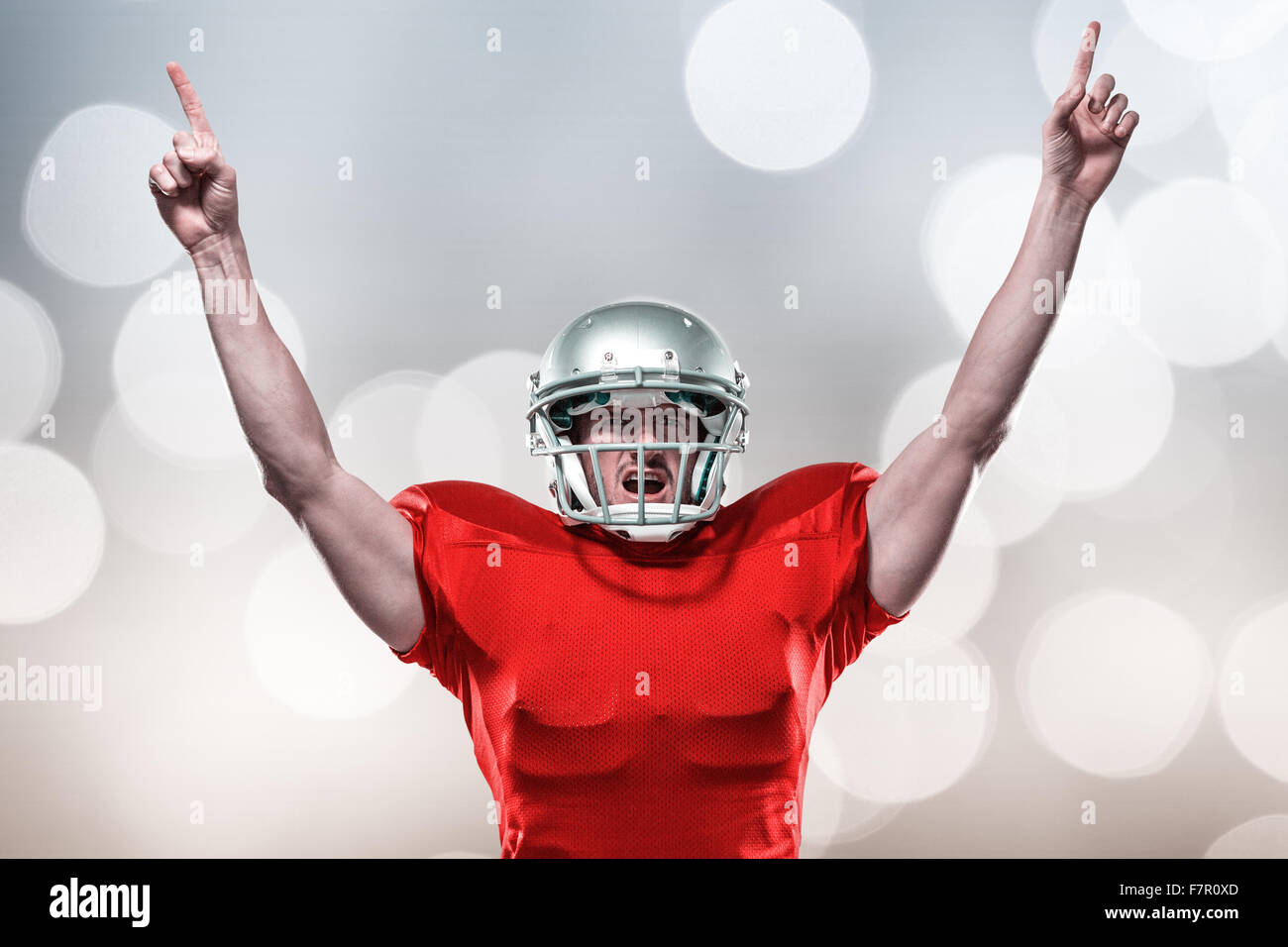 Composite image of american football player with arms raised standing ...