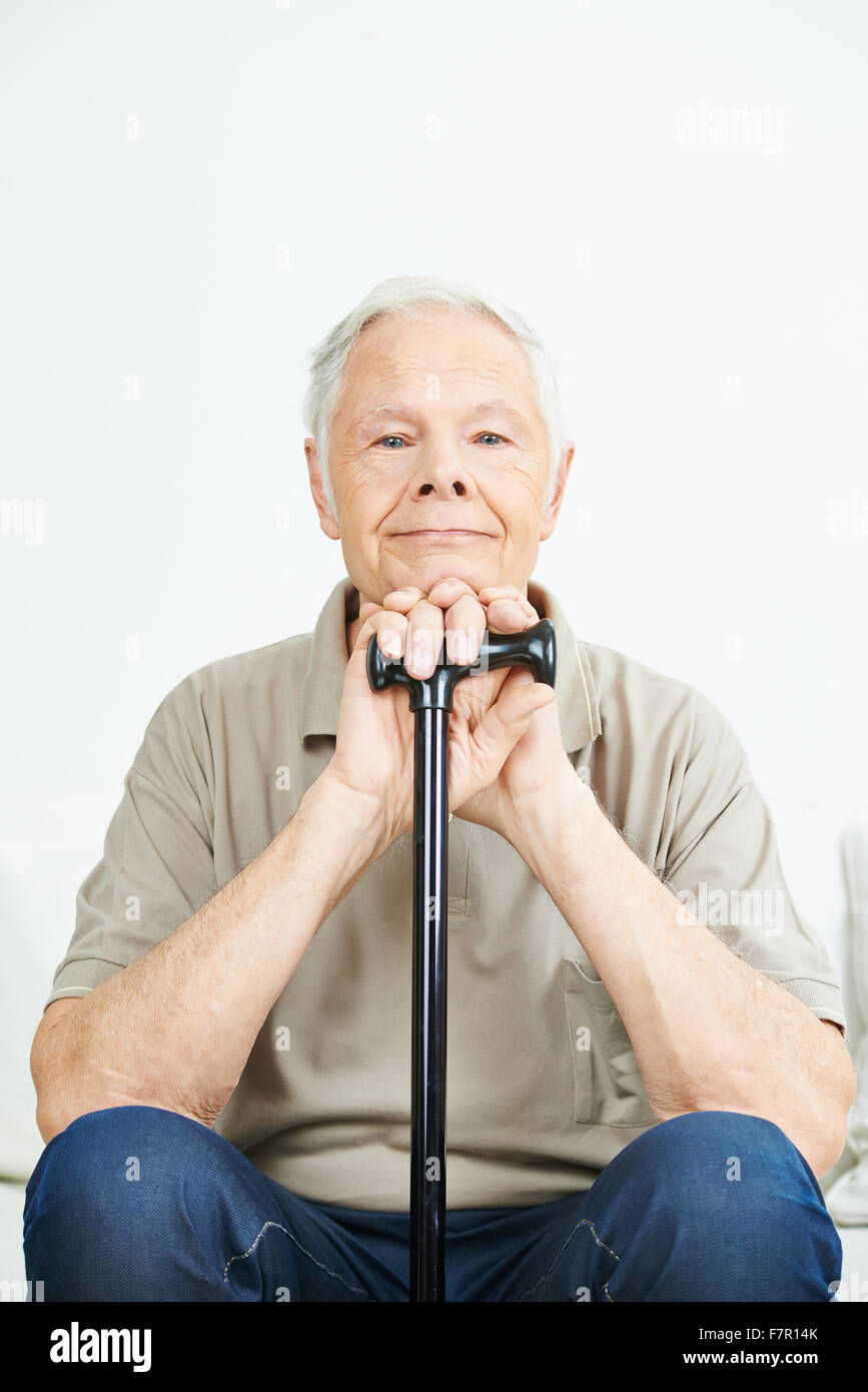 Content smiling old senior man with a cane in a nursing home Stock ...