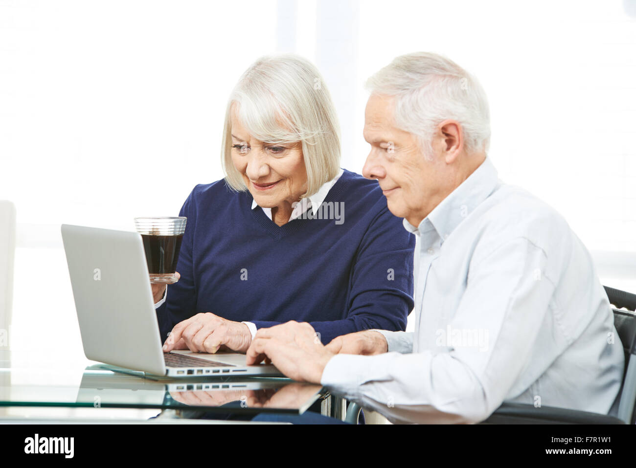 Happy senior couple with laptop computer surfing the internet Stock ...