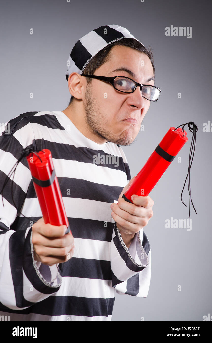 Funny prisoner with dynamite isolated on gray Stock Photo - Alamy