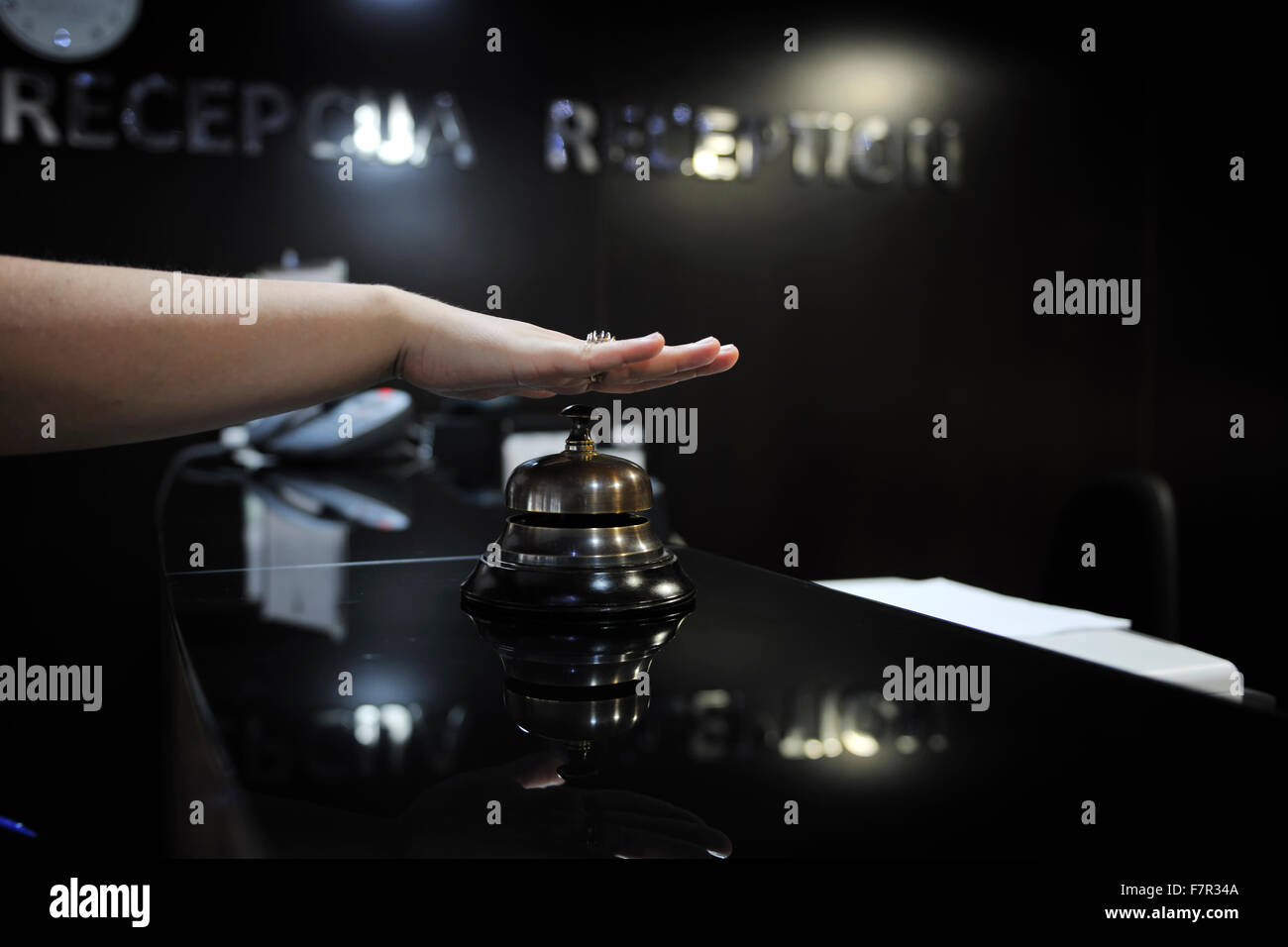 woman hand pressing reception bell in 4 stars hotel Stock Photo - Alamy