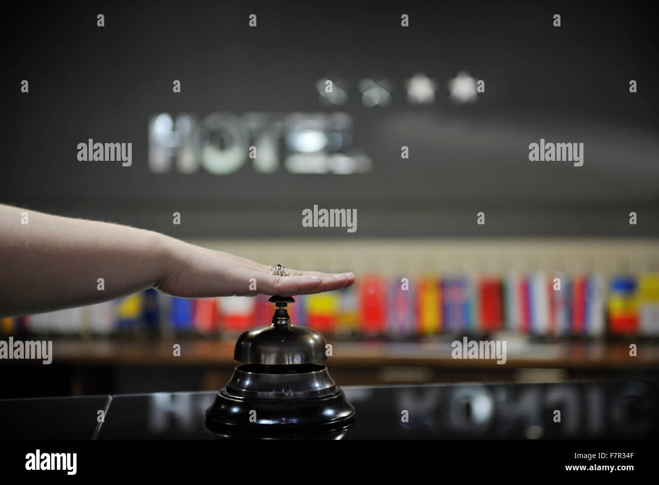 woman hand pressing reception bell in 4 stars hotel Stock Photo - Alamy
