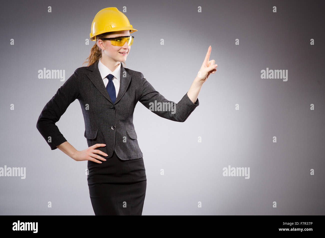Female engineer with helmet isolated on gray Stock Photo - Alamy
