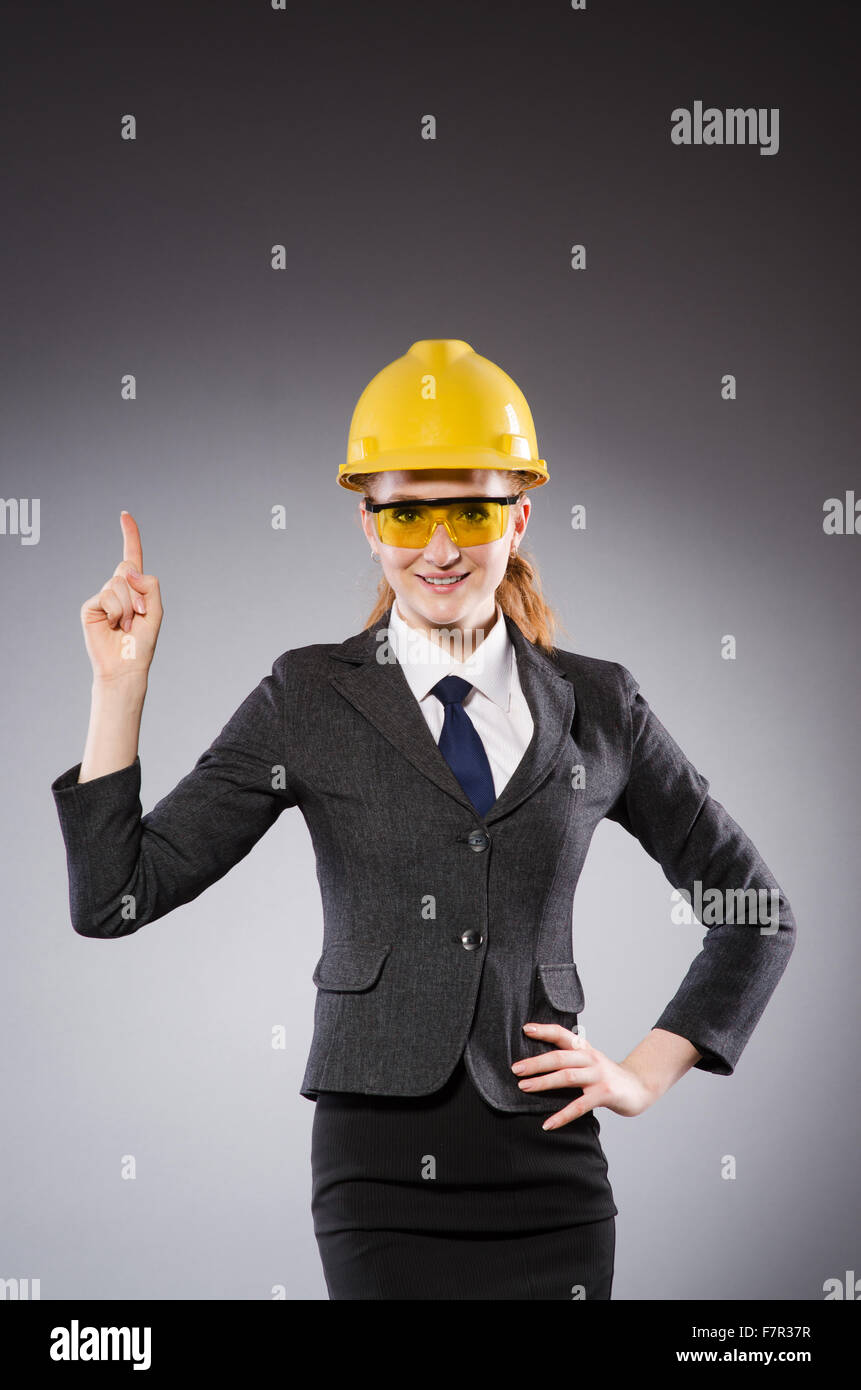 Female engineer with helmet isolated on gray Stock Photo - Alamy