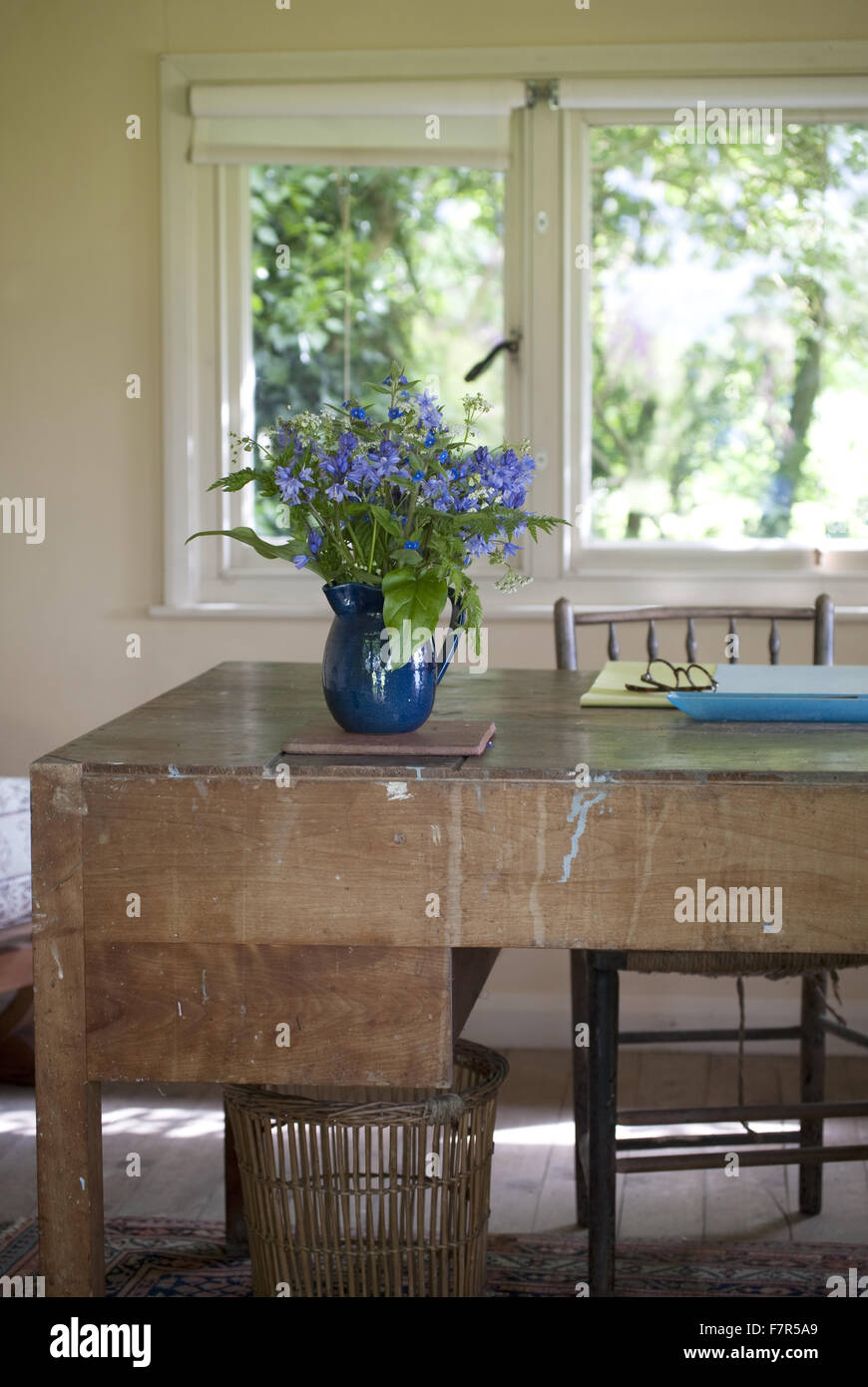 Cut flowers in a jug on the desk inside the Writing Lodge at Monk's ...