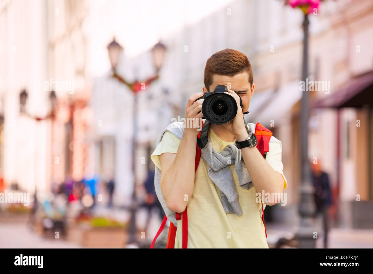 Guy shooting attractions with professional camera Stock Photo - Alamy