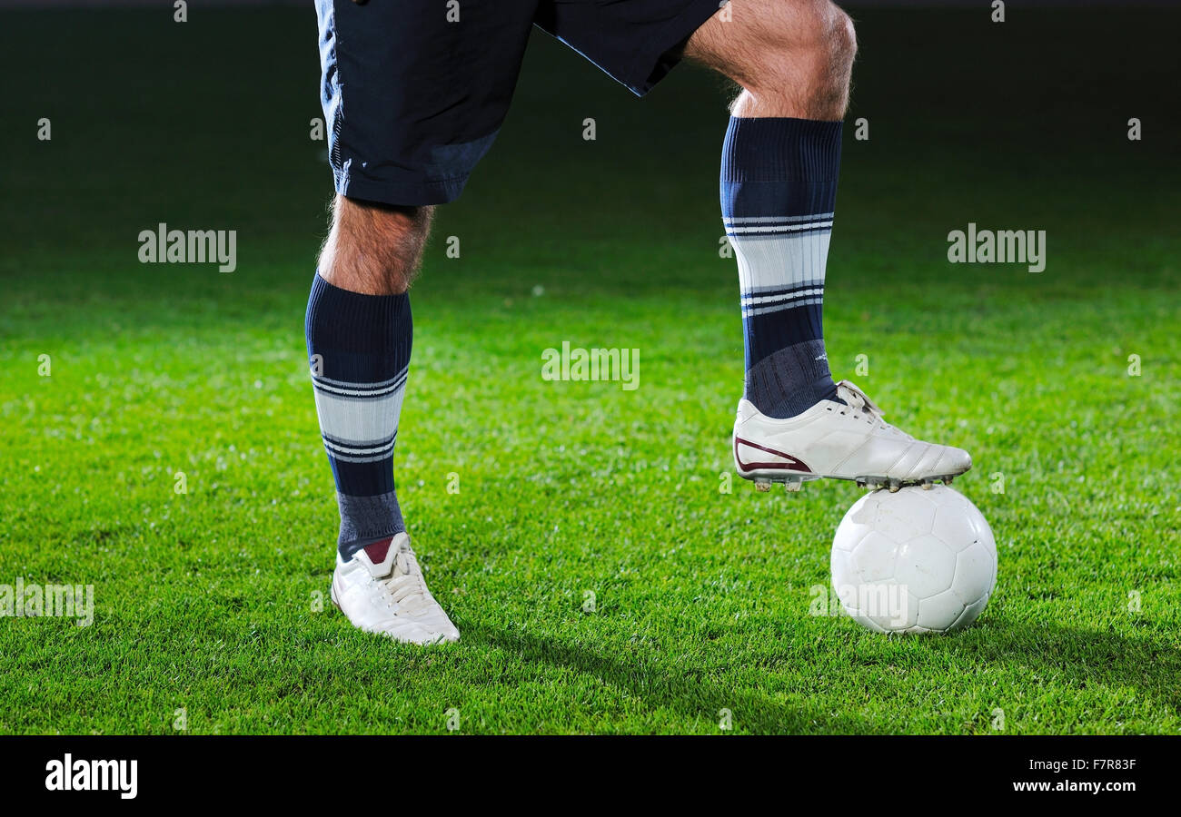 soccer player doing kick with ball on football stadium field isolated ...