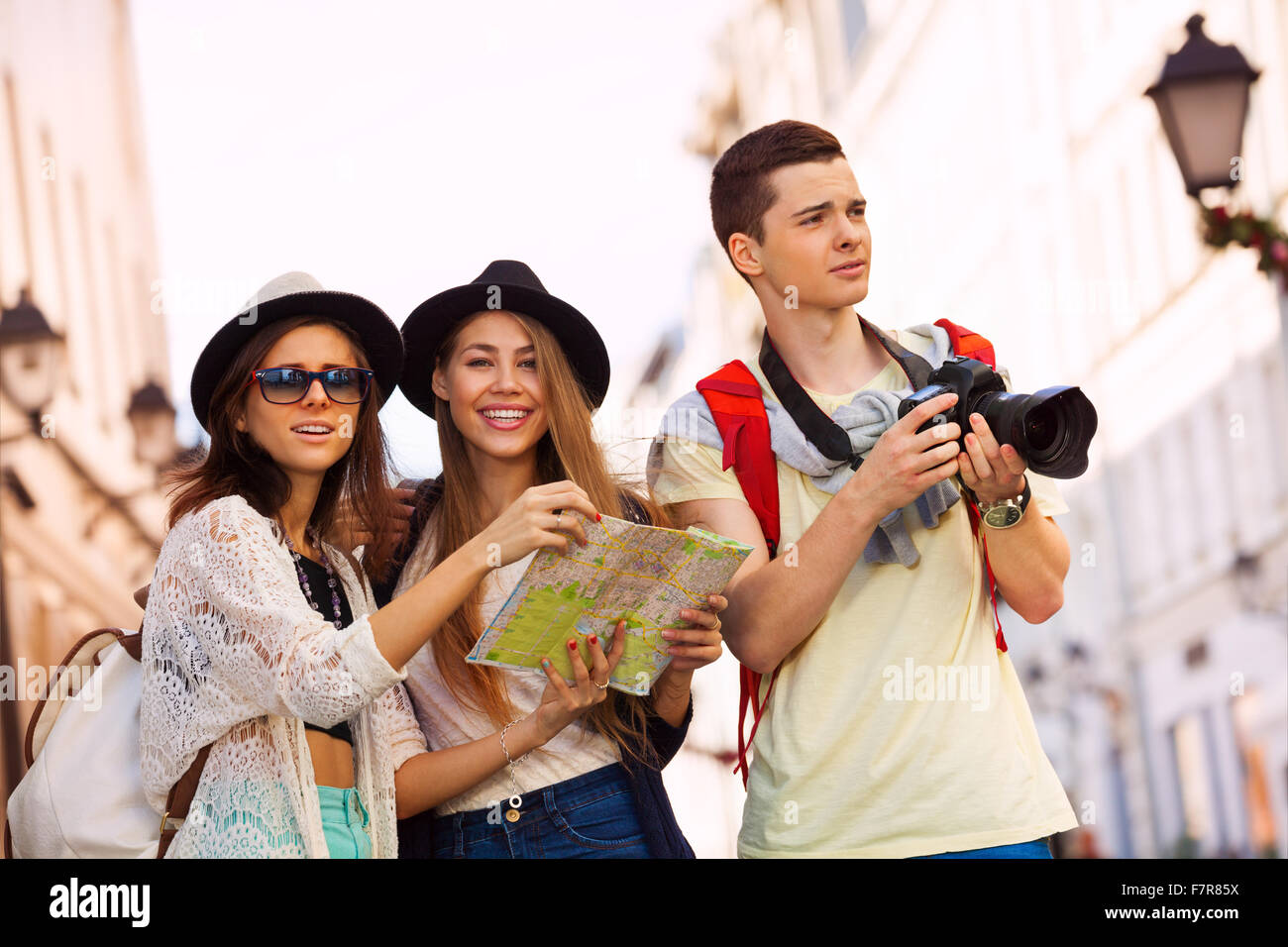 Friends with camera and city map as tourists Stock Photo - Alamy