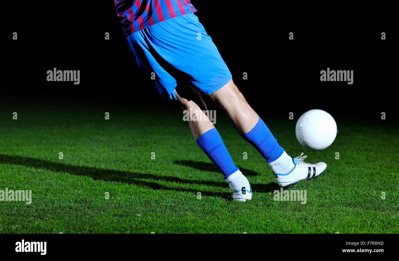 soccer player doing kick with ball on football stadium field isolated ...
