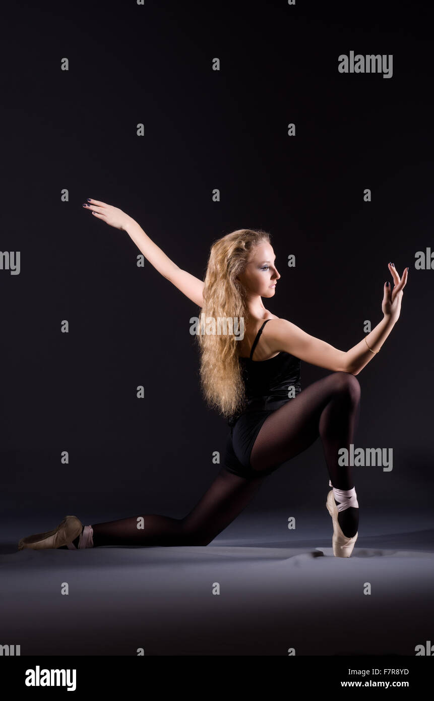 Ballerina dancing in the dark studio Stock Photo - Alamy