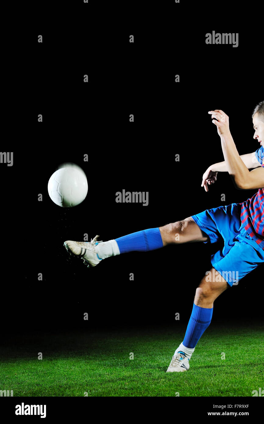 soccer player doing kick with ball on football stadium field isolated ...