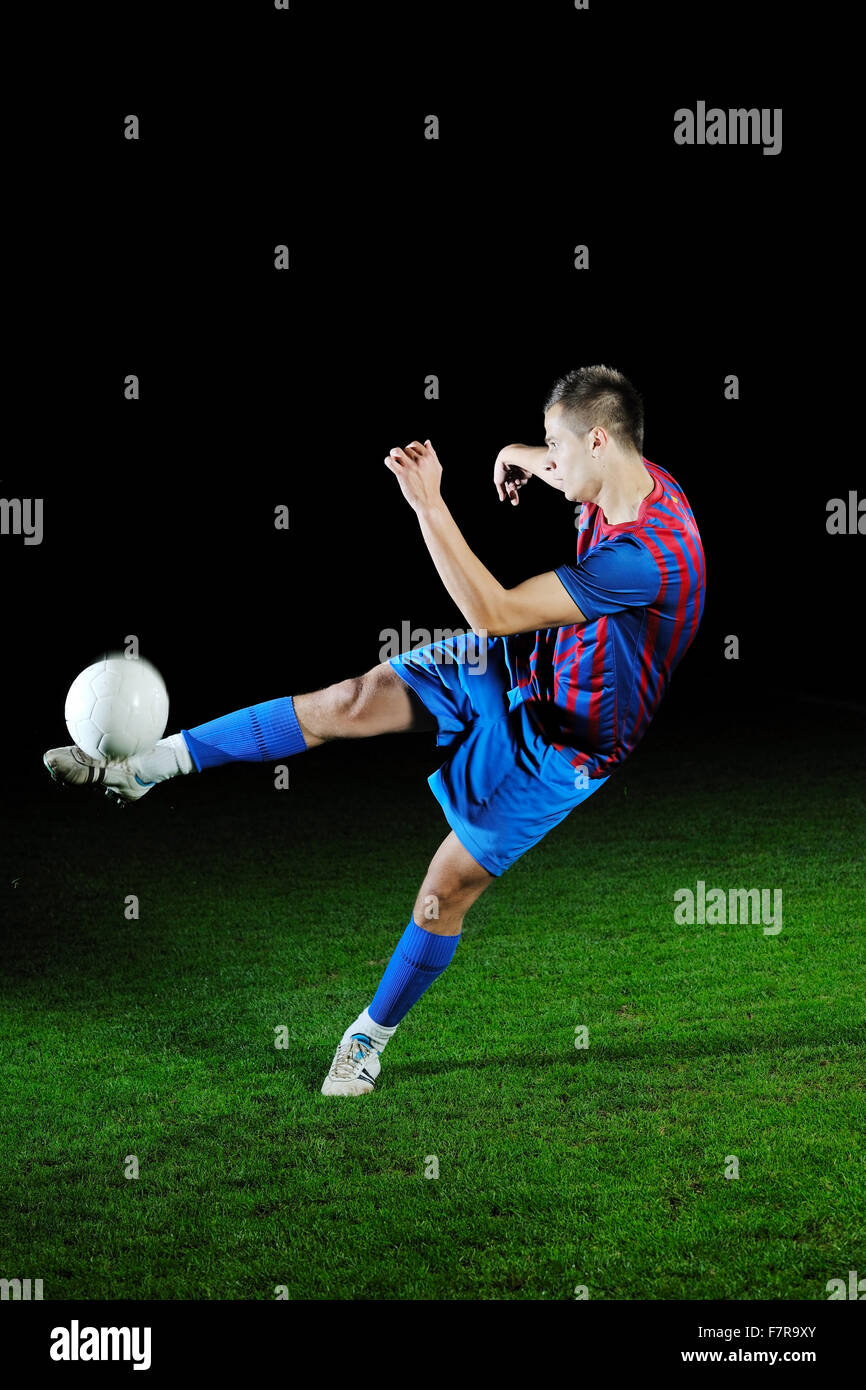 soccer player doing kick with ball on football stadium field isolated ...