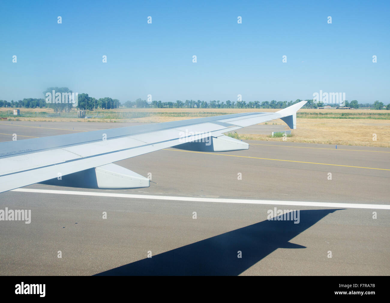 Airplane wing out of window Stock Photo - Alamy
