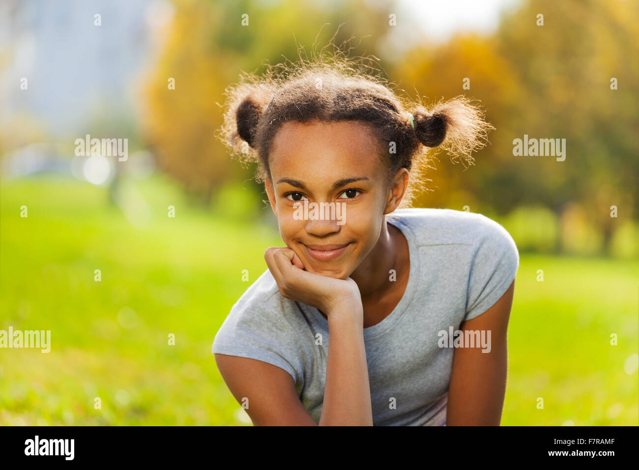 Portrait of beautiful African girl on green grass Stock Photo - Alamy