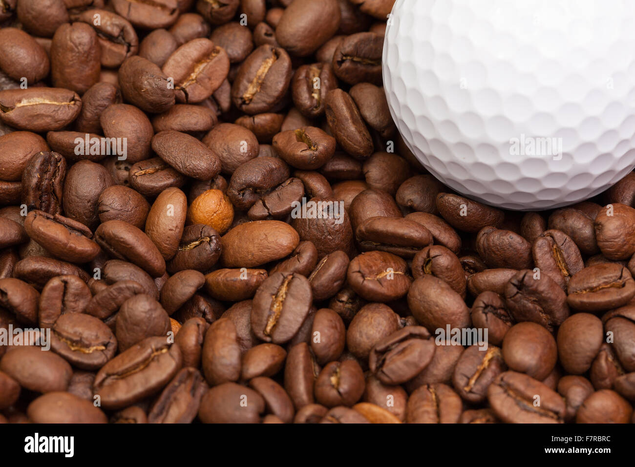 Coffee beans and white golf ball Stock Photo - Alamy