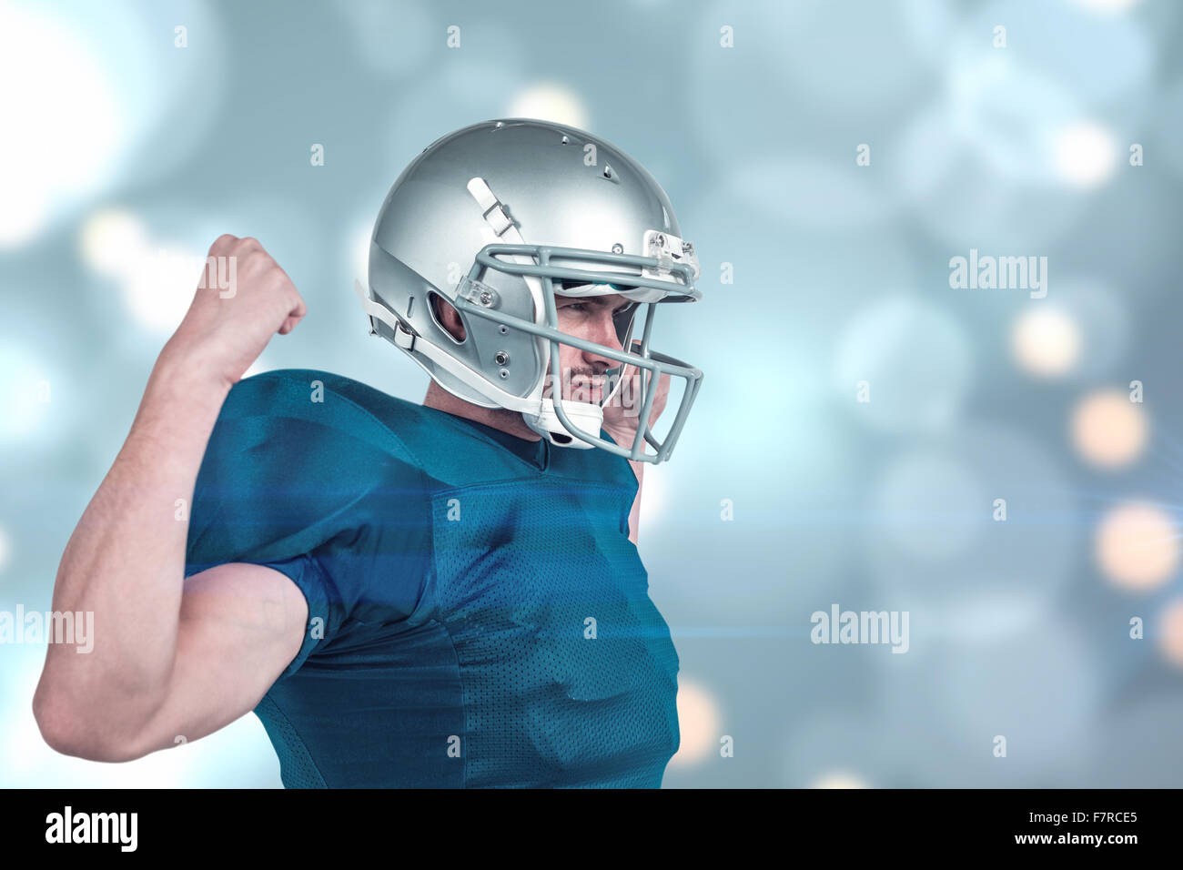 Composite image of confident american football player flexing muscles ...