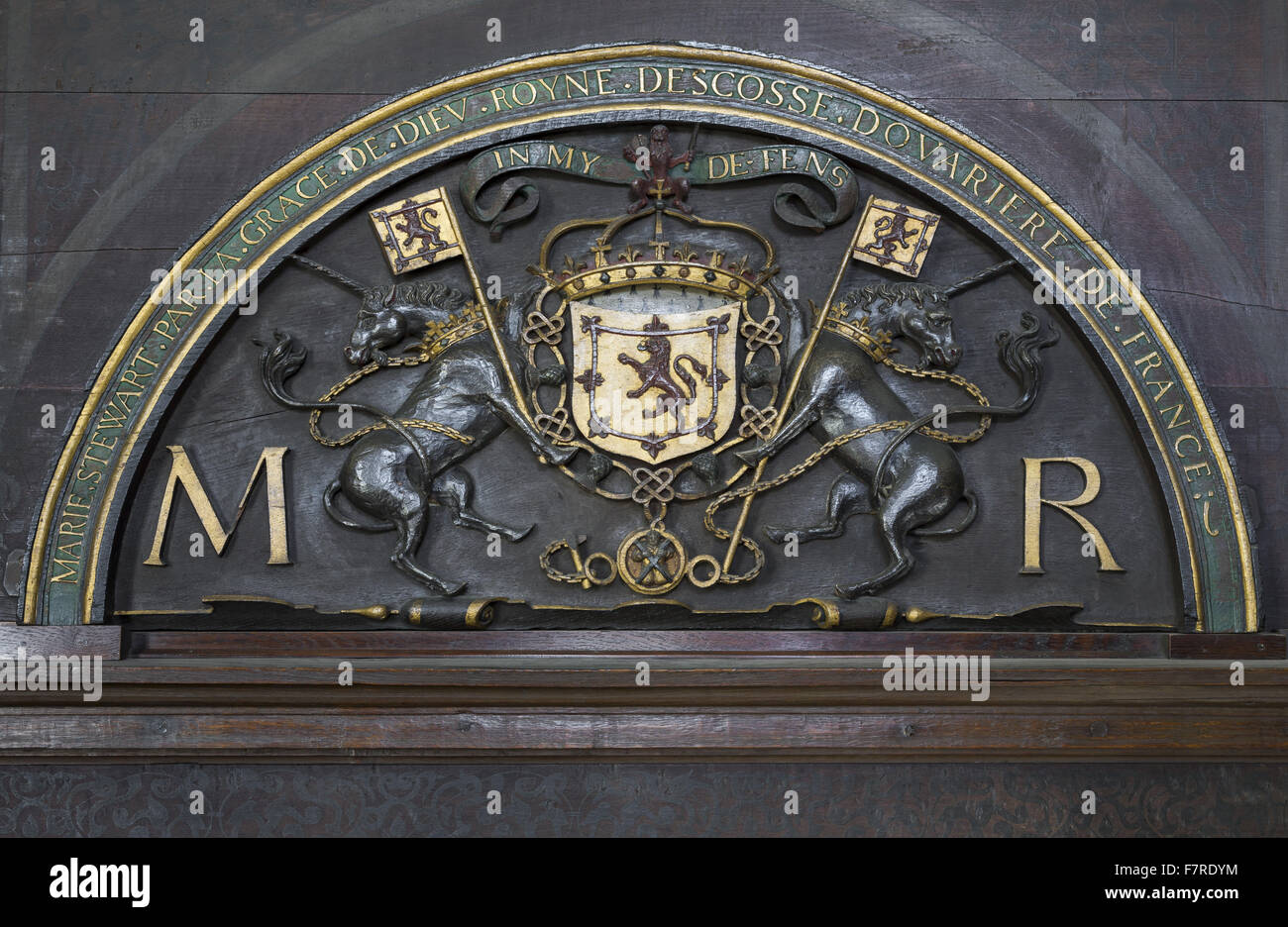 A carved armorial panel featuring the letters 'M.R.', from above the ...