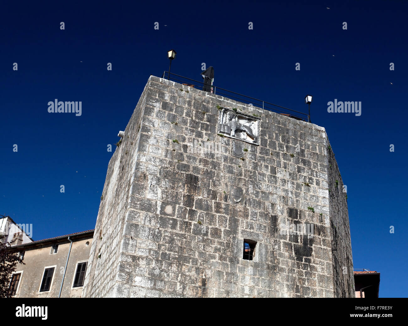 Detail of a very old tower with a symbol on it. Porec, Croatia Stock ...