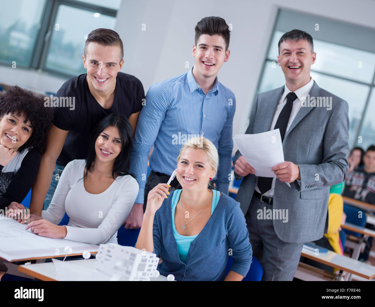 group of students with teacher in computer lab classrom learrning ...