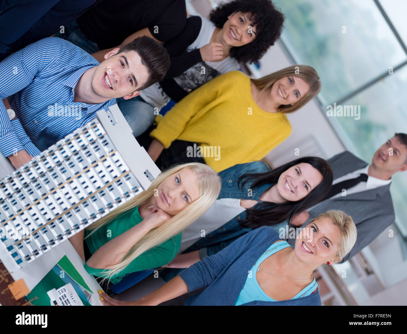 group of students with teacher in computer lab classrom learrning ...