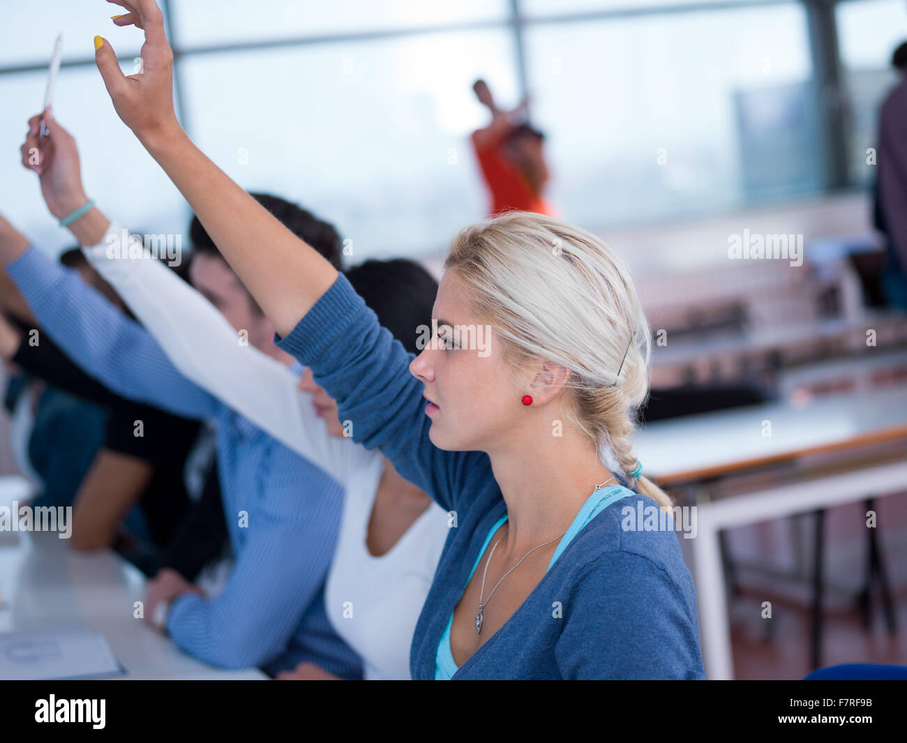 students group raise hands up in classroom Stock Photo - Alamy