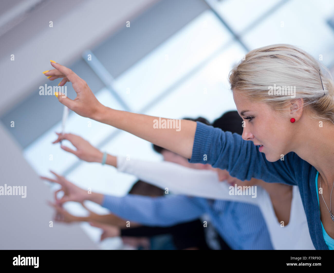 students group raise hands up in classroom Stock Photo - Alamy