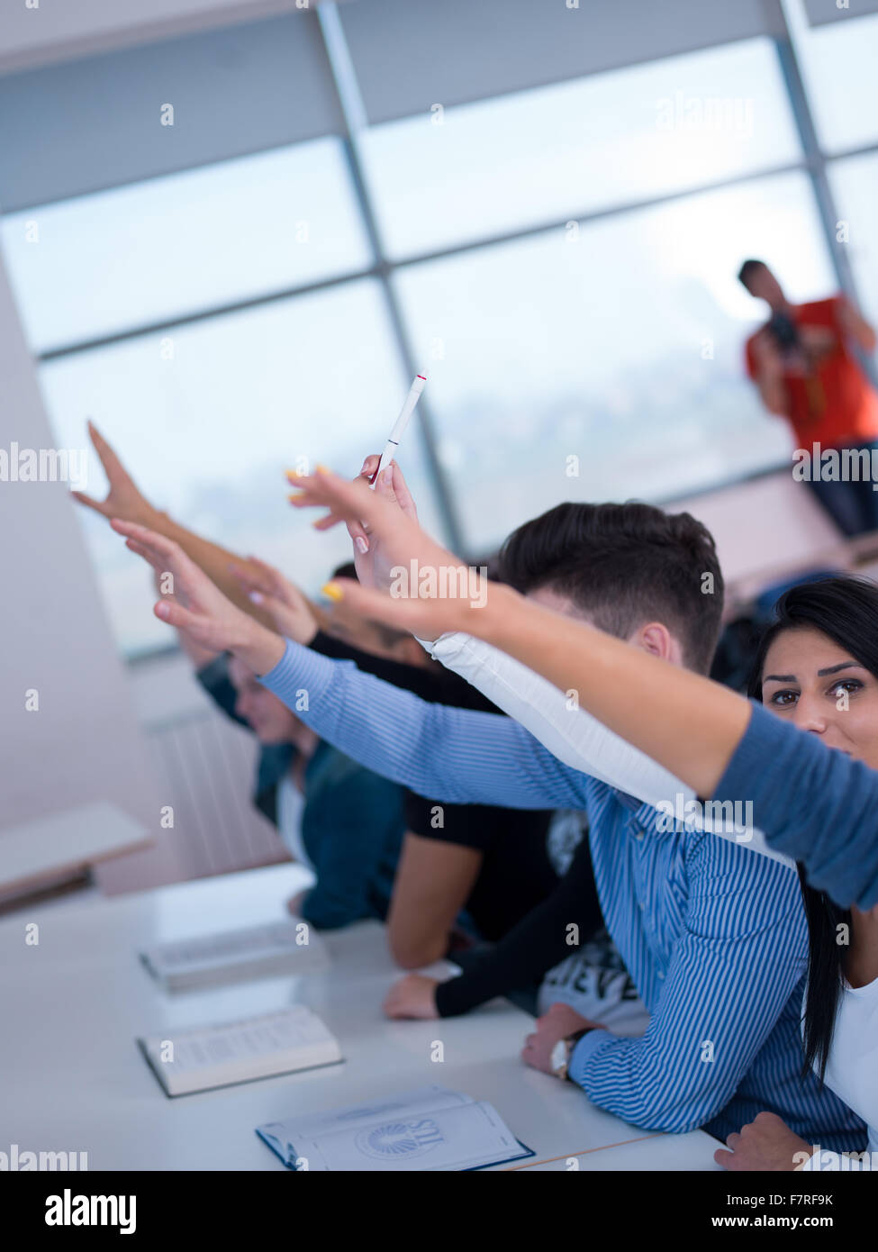 students group raise hands up in classroom Stock Photo - Alamy